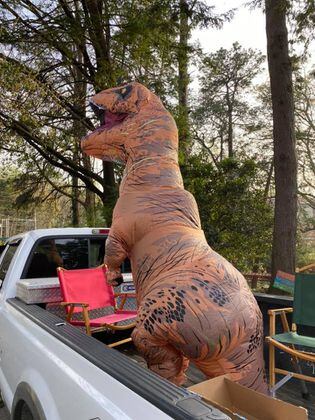 Couple does friendly drive-by with T. rex in truck